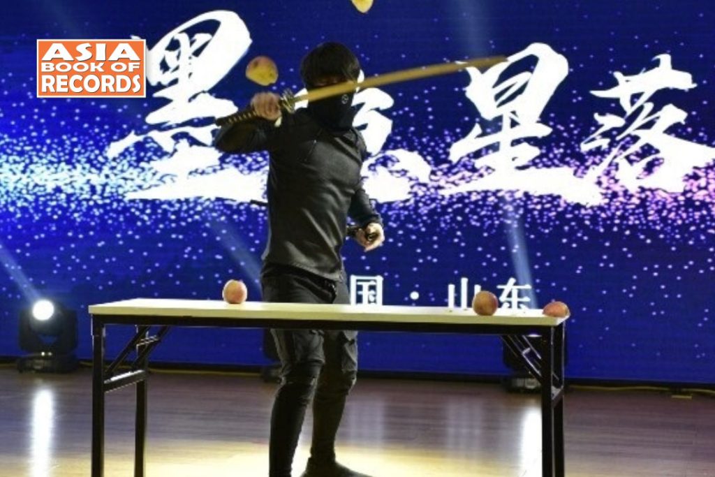 Fastest to cut five apples in the air using a bamboo sword - Asia Book ...