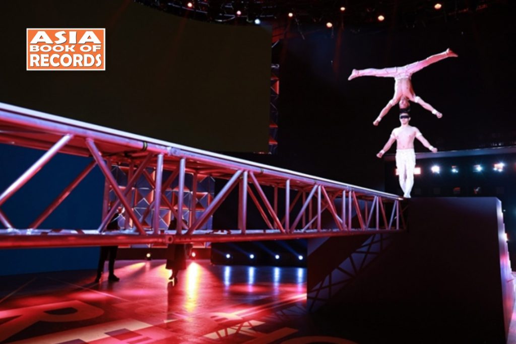 Great balancing act balancing vertically atop a walking person’s head ...